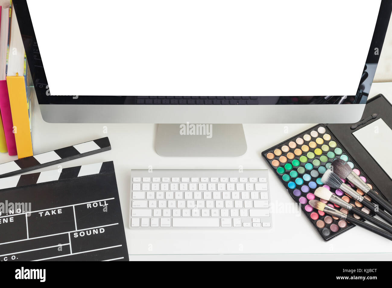 Makeup artist workplace with makeup palette with brushes, keyboard ...