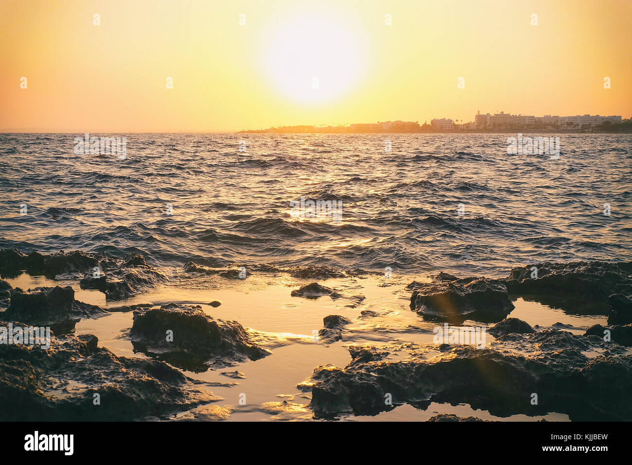 Rocky coast of sea on sunset Stock Photo - Alamy