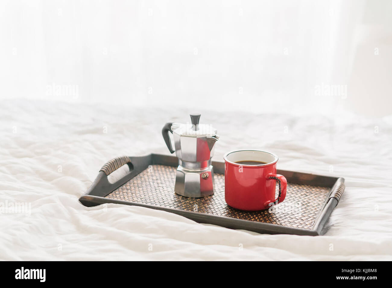 Tray with coffee mug, coffee maker on white bed in bedroom Stock Photo ...