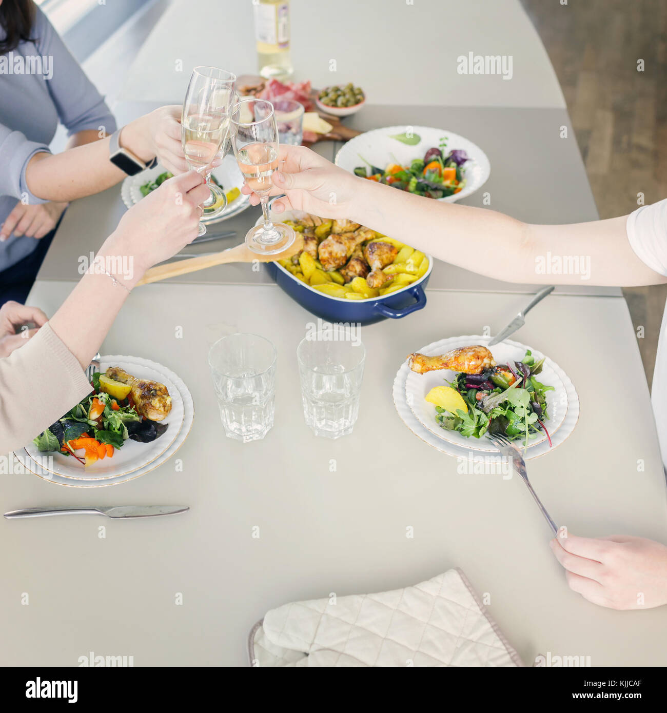 Young women enjoying dinner with champagne Stock Photo - Alamy