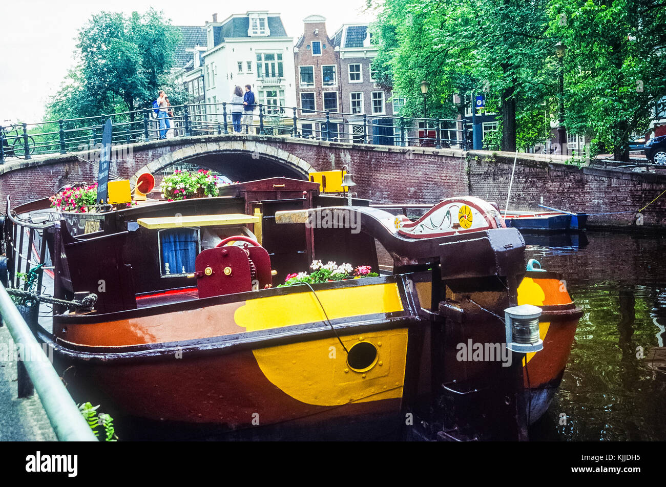 Boat berthed at bridge in Amsterdam Stock Photo - Alamy