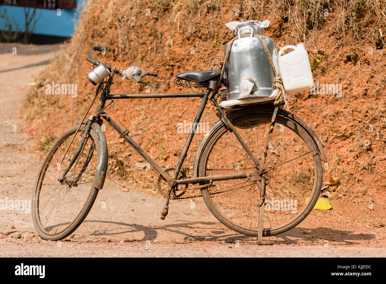 An old and rusty bicycle stands on the road side in Kerala, India. It ...