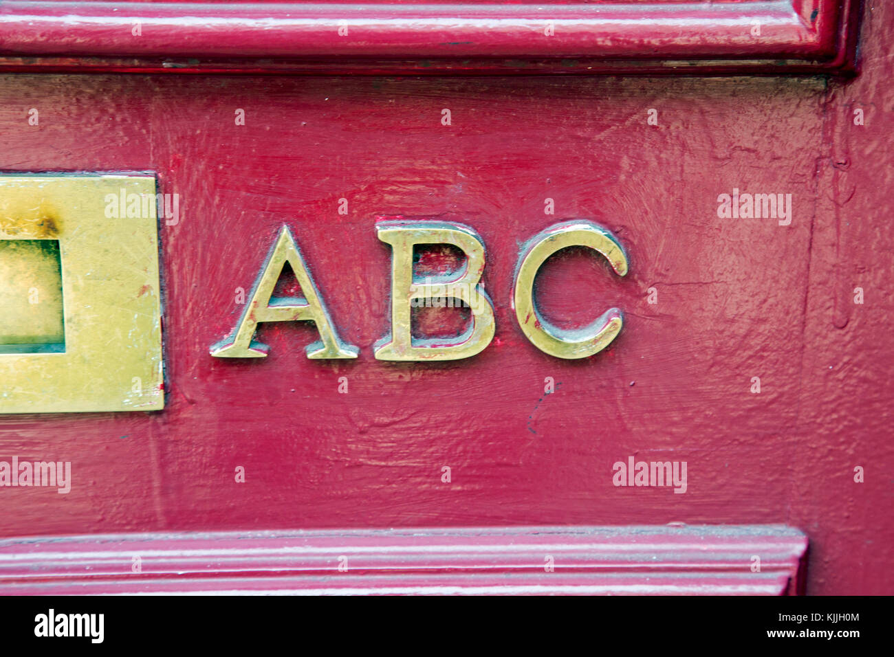 An old red door with ABC by the letterbox Stock Photo - Alamy