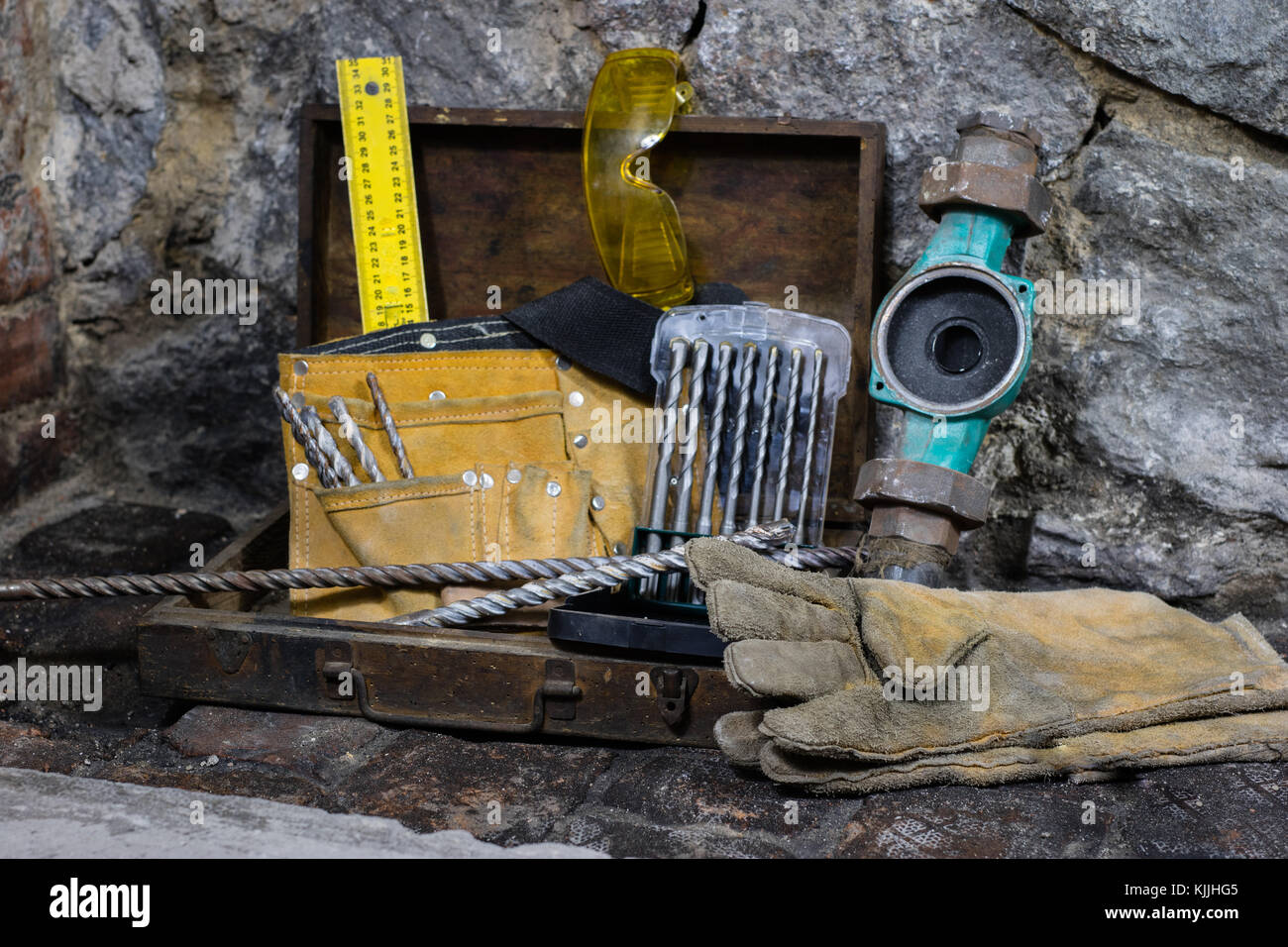 Construction tools for building a house on a stone wall. Hammer, helmet ...
