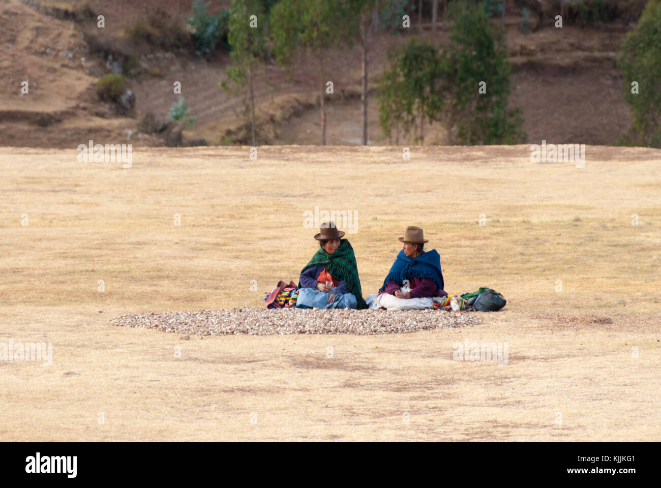 CHINCHERO, PERU - AUGUST 20, 2006: Female peasants collecting moraya ...