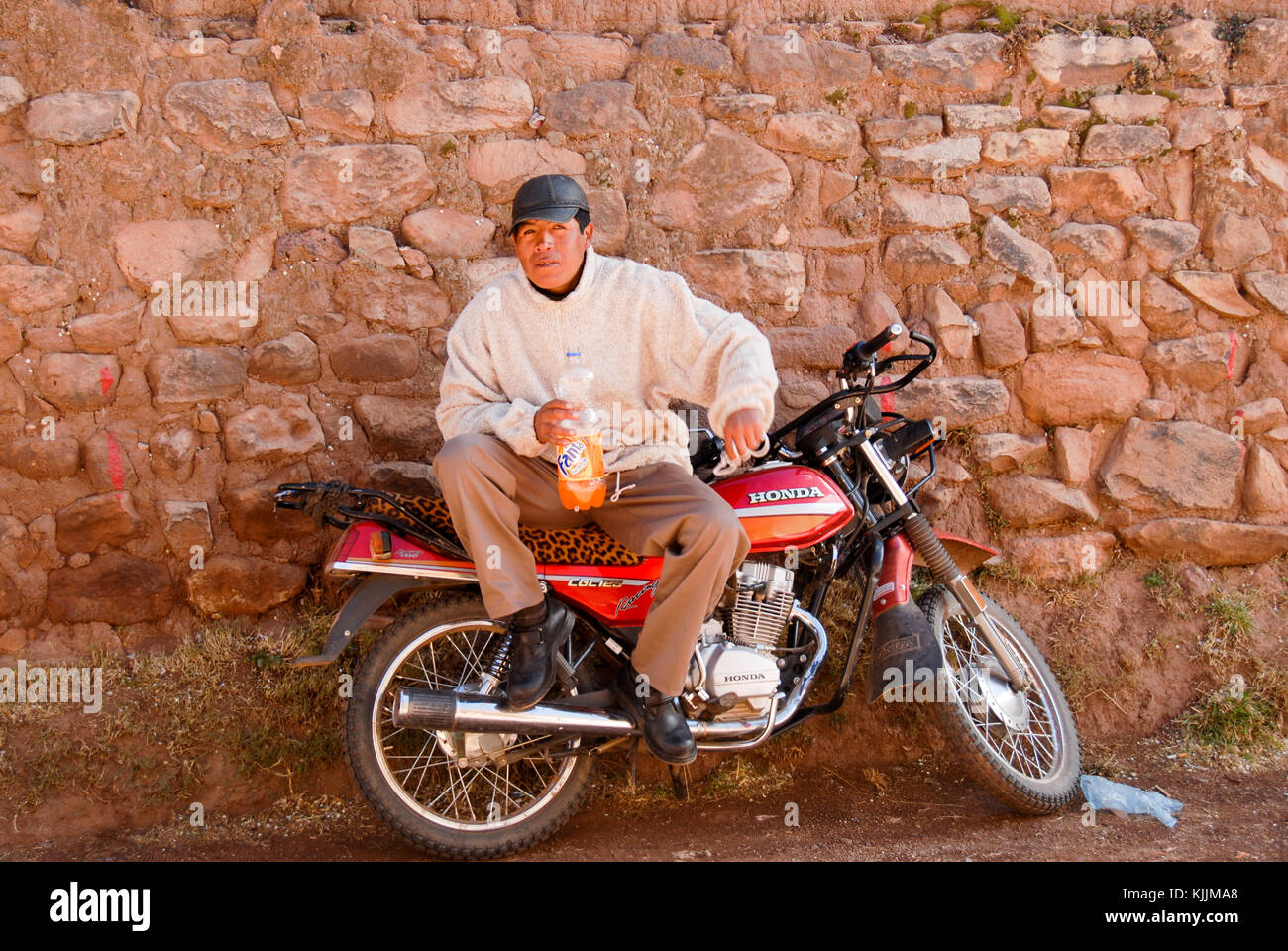 AUGUST 16, 2006 - PUKARA, PERU: Peruvian on a motorcycle in the ...