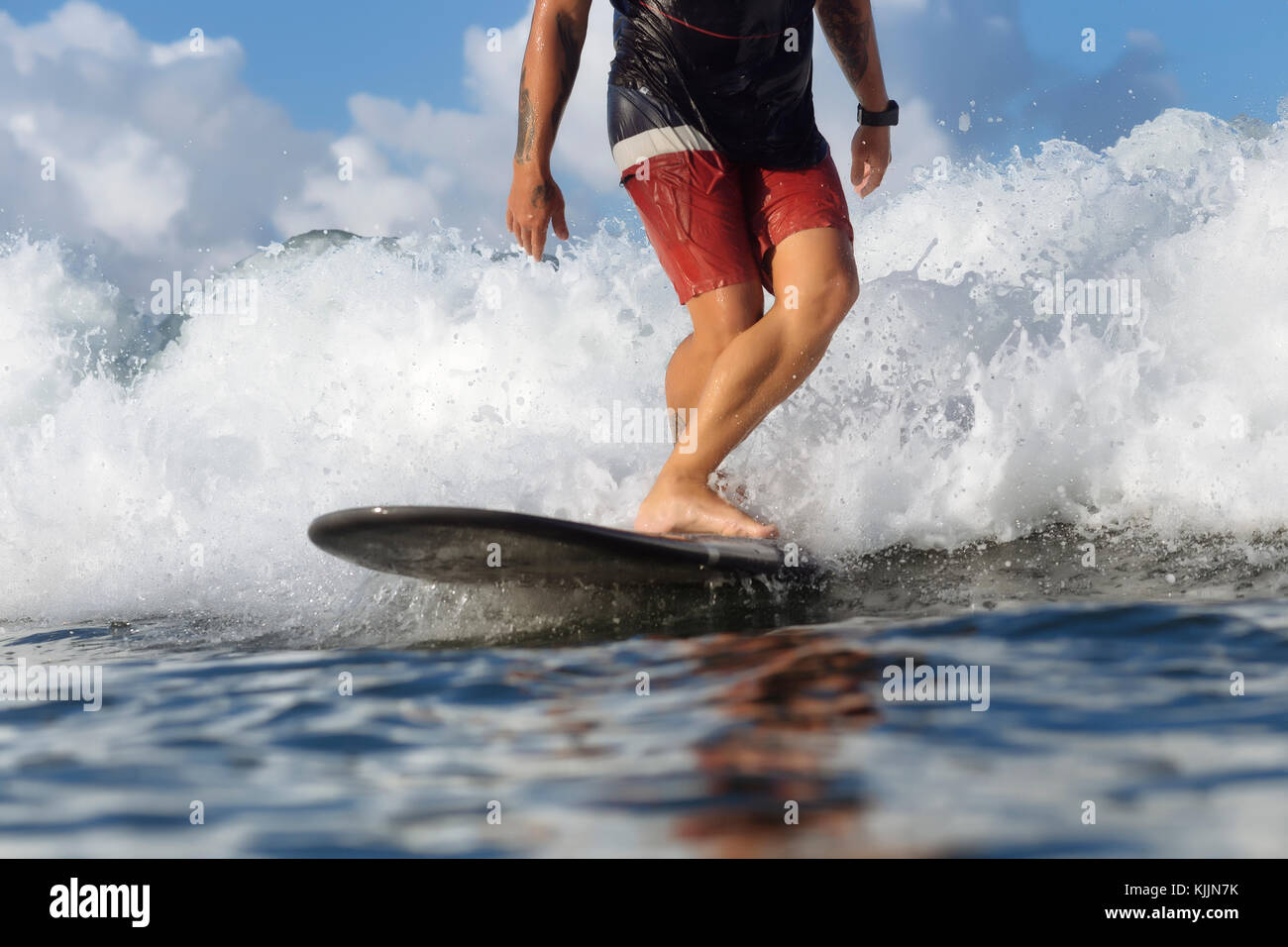 Indonesia, Bali, legs of surfer on a wave Stock Photo - Alamy