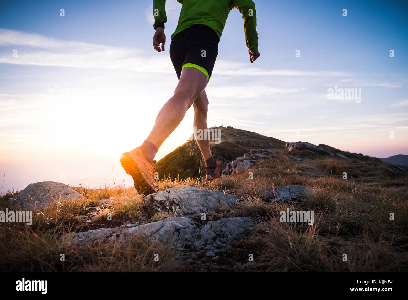 Italy, man running on mountain trail Stock Photo - Alamy