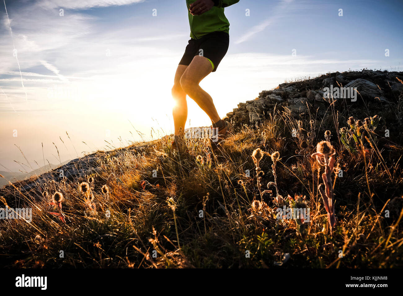 Italy, man running on mountain trail Stock Photo - Alamy