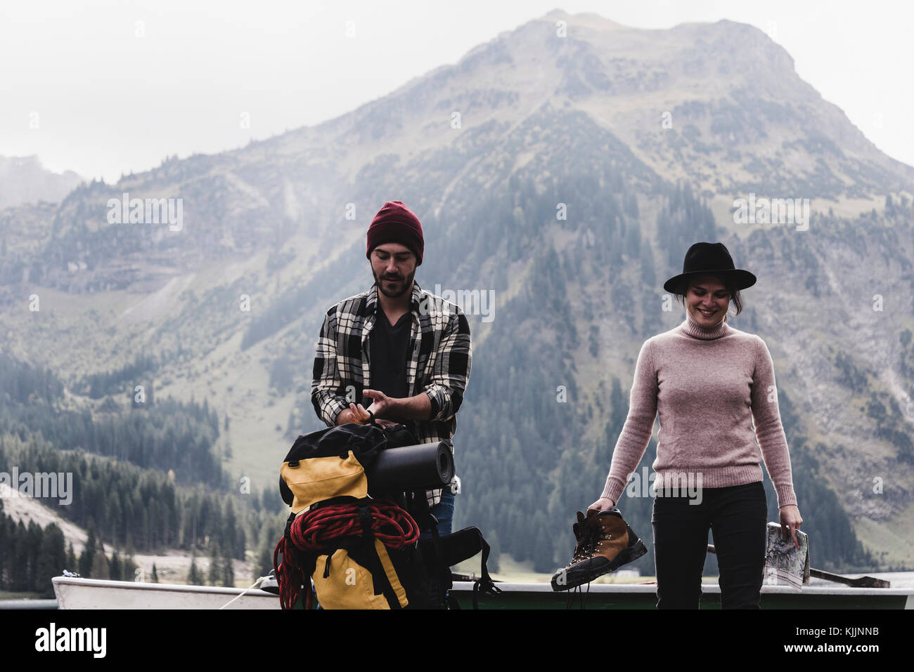 Austria, Tyrol, Alps, couple with backpack and hiking boots in alpine ...