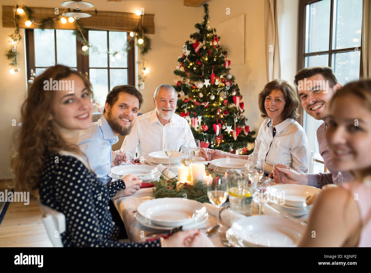Happy family at Christmas dinner table Stock Photo - Alamy