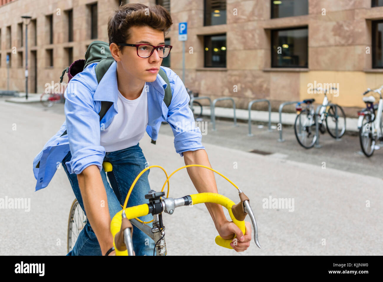 Portrait of young man riding on racing cycle Stock Photo - Alamy