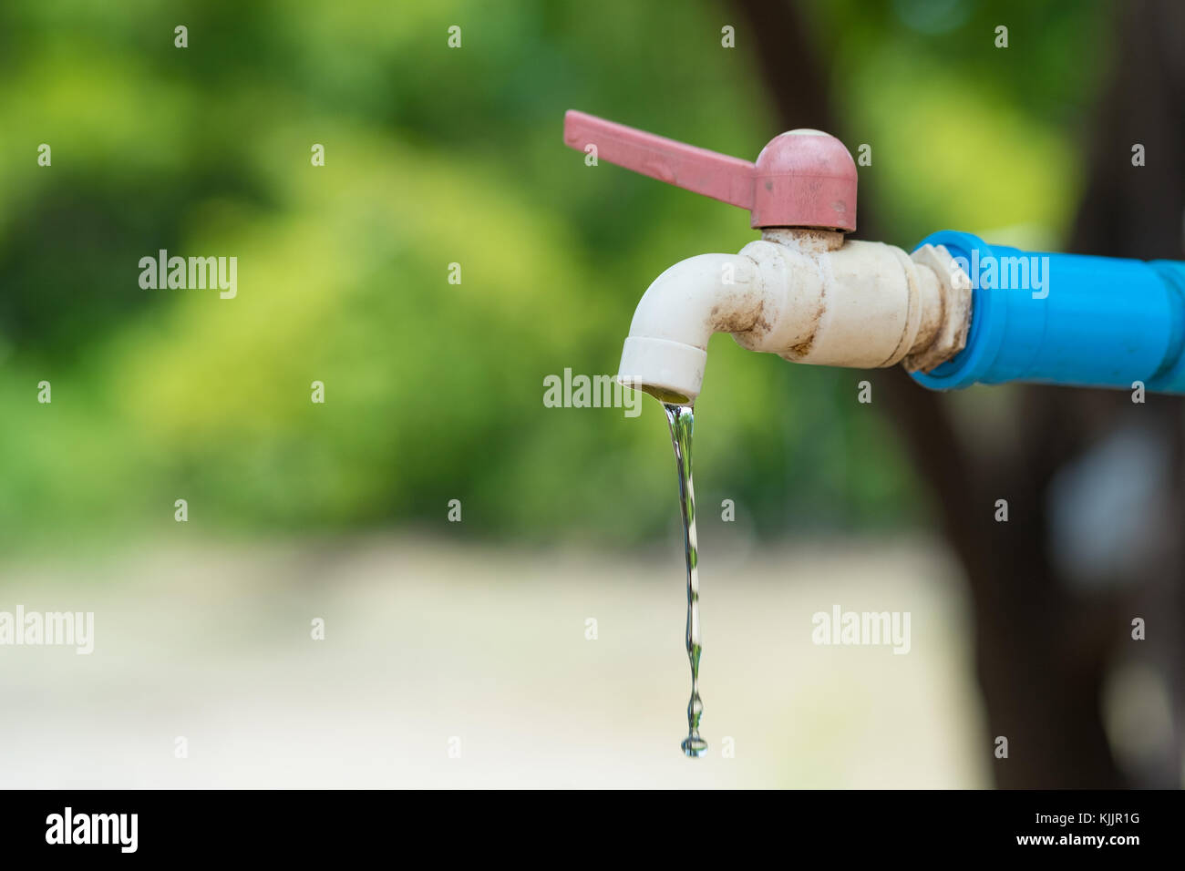 Water drop from old chrome faucet and water pipeline, rusty tap with ...