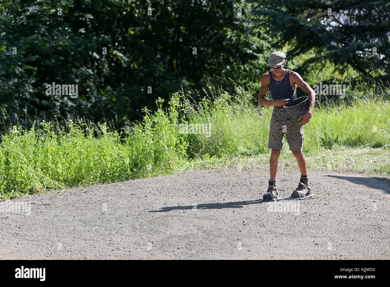 Gardner planting grass seed. France Stock Photo - Alamy