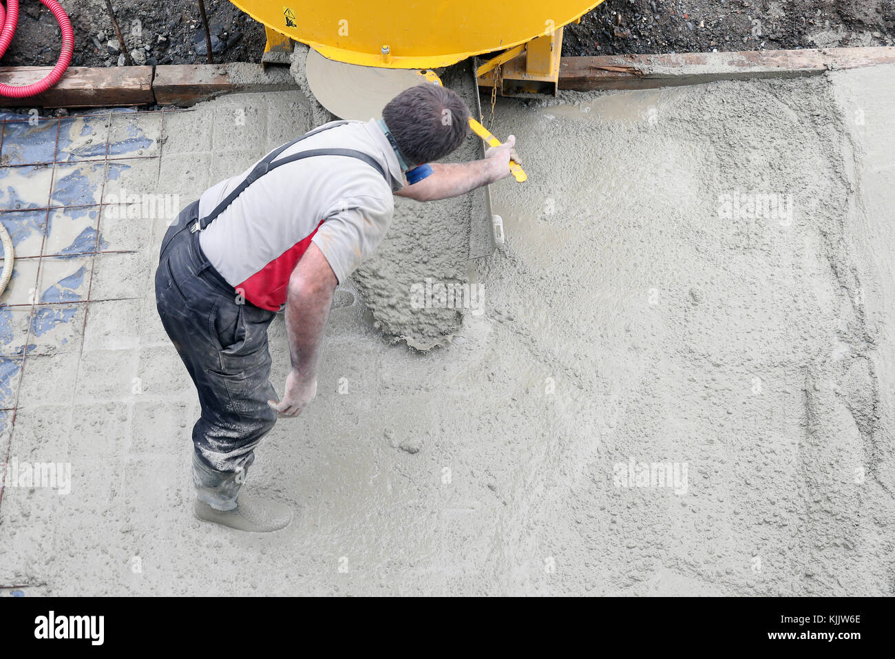 Construction site. Worker pouring concrete. France Stock Photo - Alamy