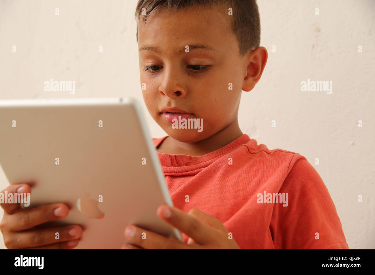 Boy using a digital tablet Stock Photo - Alamy