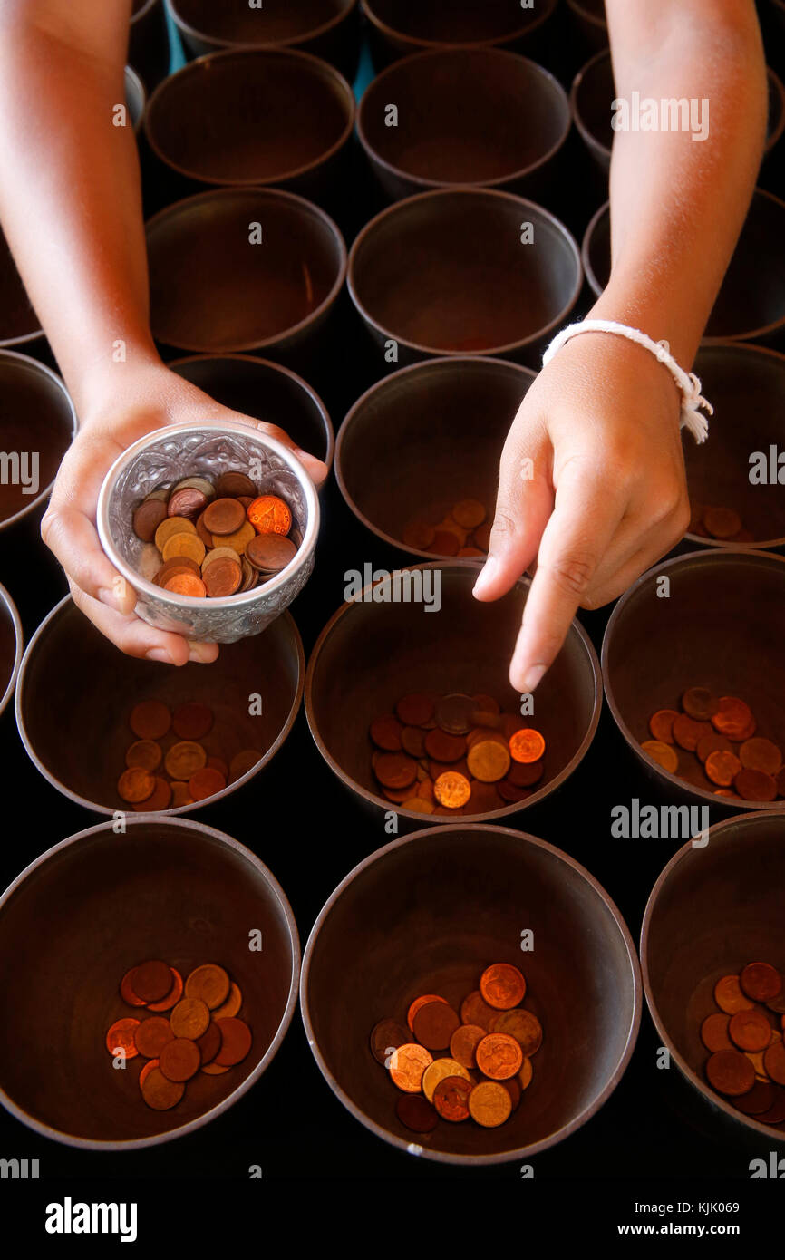 Child offering coins in Wat Suandok, Chiang Mai. Thailand Stock Photo ...