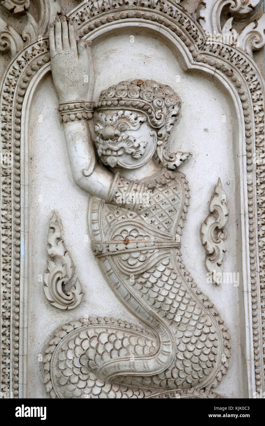 Wat Mahathat, Phetchaburi. Relief depicting a yakkha (head) on a snake ...