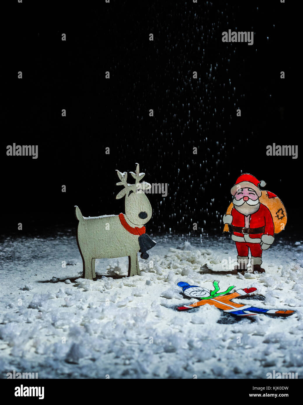 Paper figures of the child as a snow angel Santa Claus and deer. Hand ...