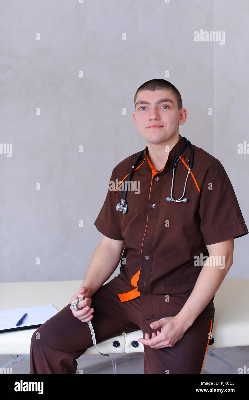 Professional male therapist looks at camera with smile and sitti Stock ...