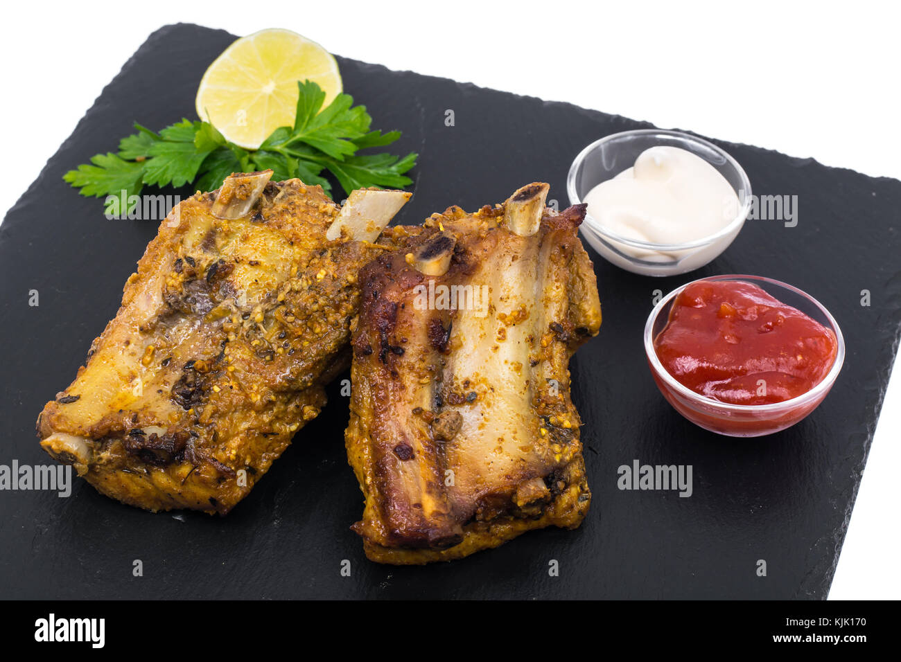Pork ribs on black stone plate. Studio Photo Stock Photo - Alamy