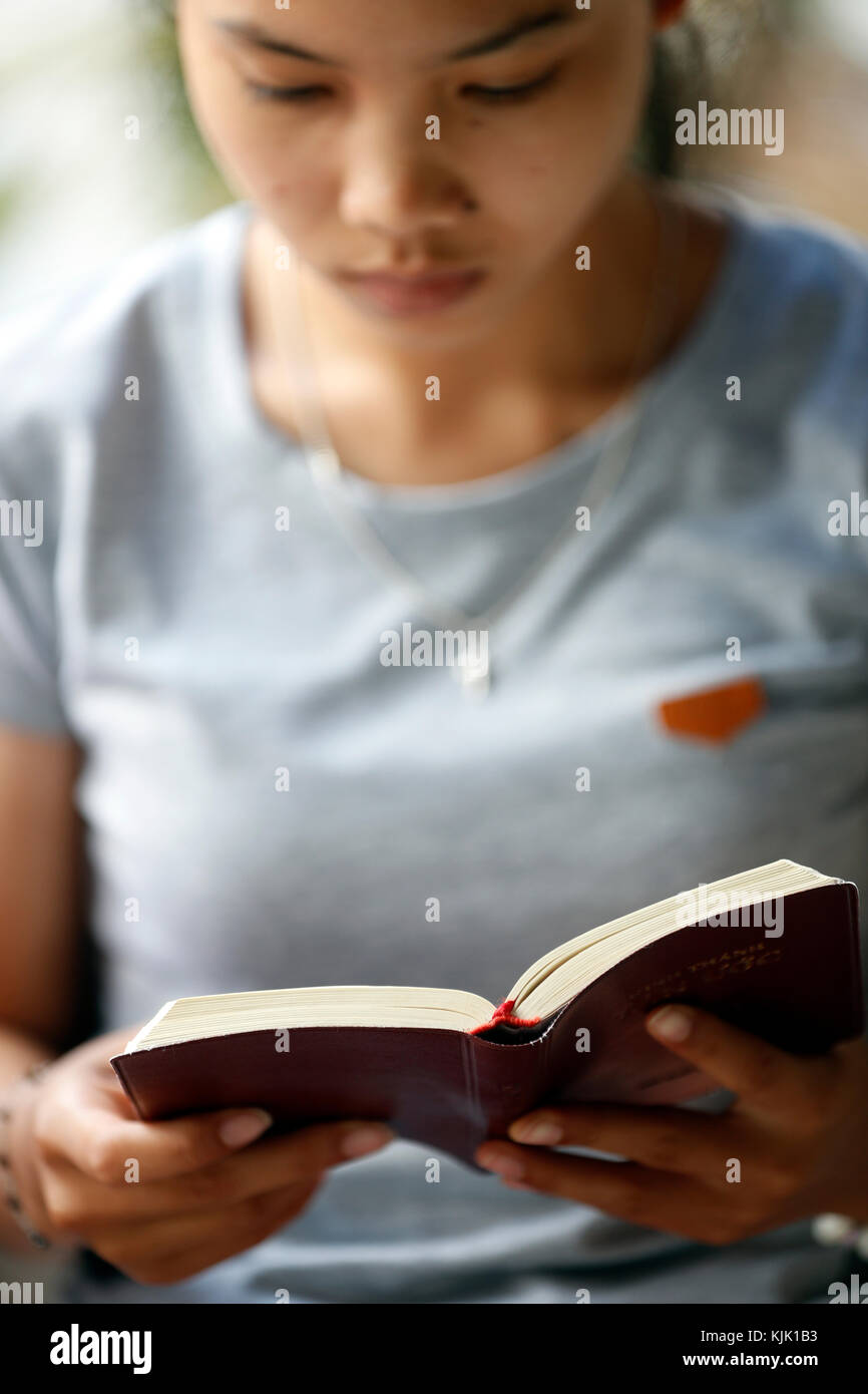 Girl reading bible hi-res stock photography and images - Alamy