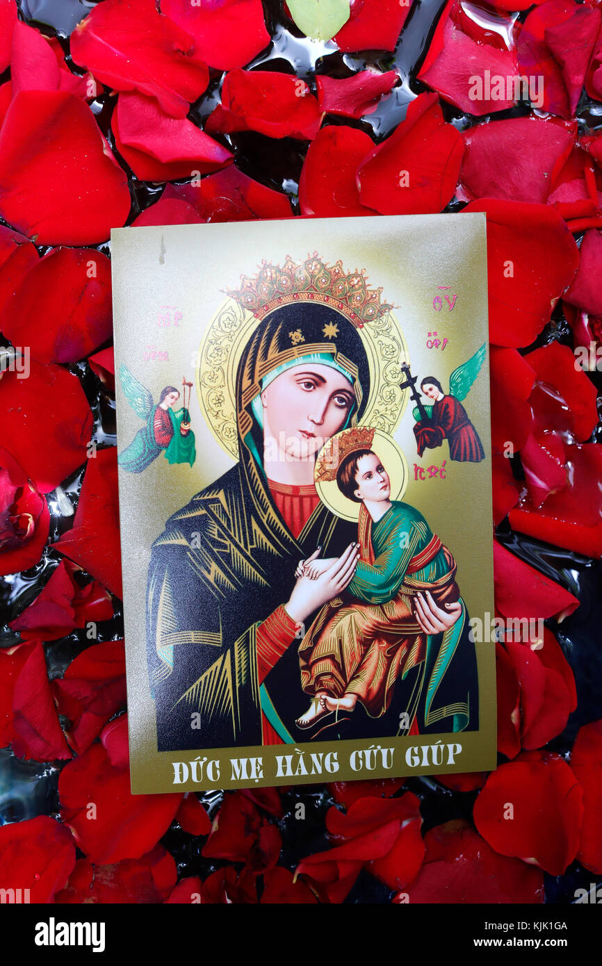 Holy image of Virgin Mary and Child on red roses. Vung Tau. Vietnam ...