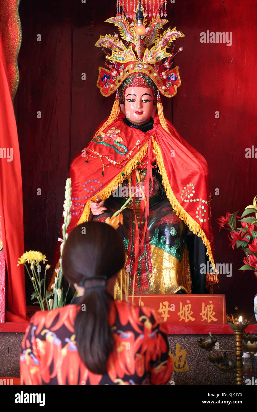 Woman in prayer holding incense sticks. Taoist temple. Ho Chi Minh City ...