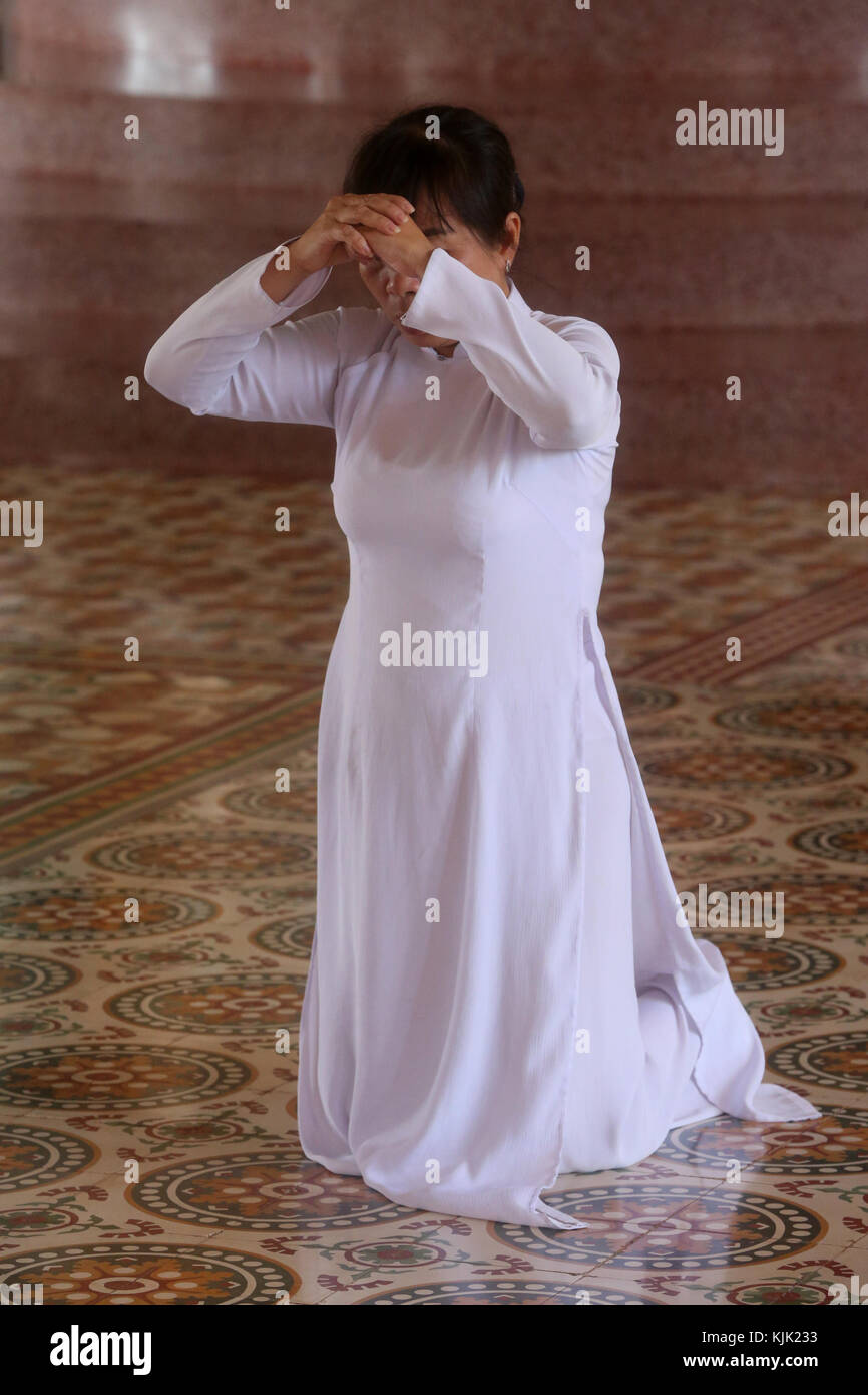 Cao Dai Holy See Temple. Caodaist service. Woman praying. Thay Ninh ...