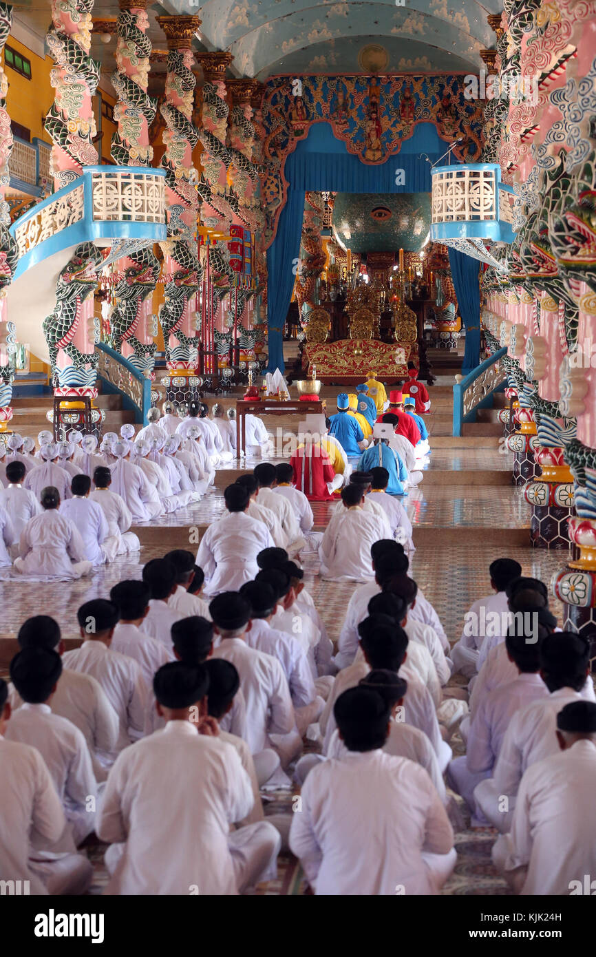 Cao Dai Holy See Temple. Praying devout men and women, ceremonial ...