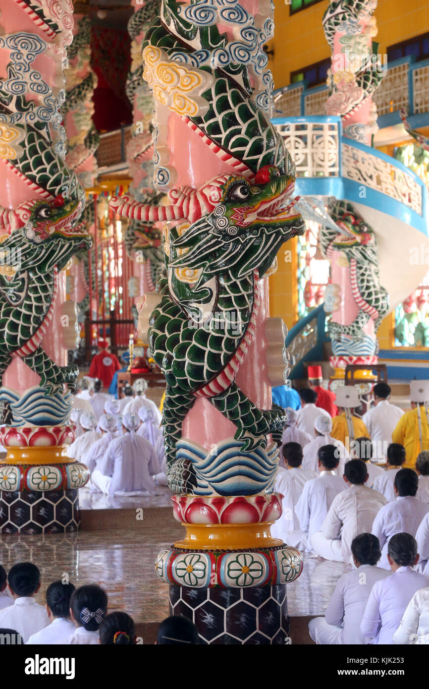 Cao Dai Holy See Temple. Caodaist service under dragon column. Thay ...