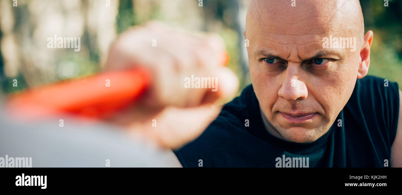 Knife threat. Kapap instructor demonstrates martial arts self defense ...