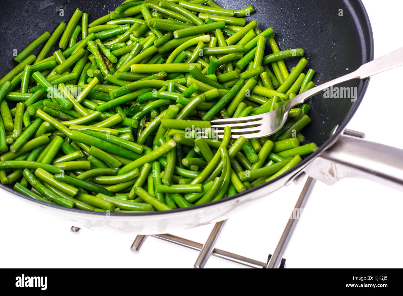 Fried pods of green beans in frying pan. Studio Photo Stock Photo - Alamy