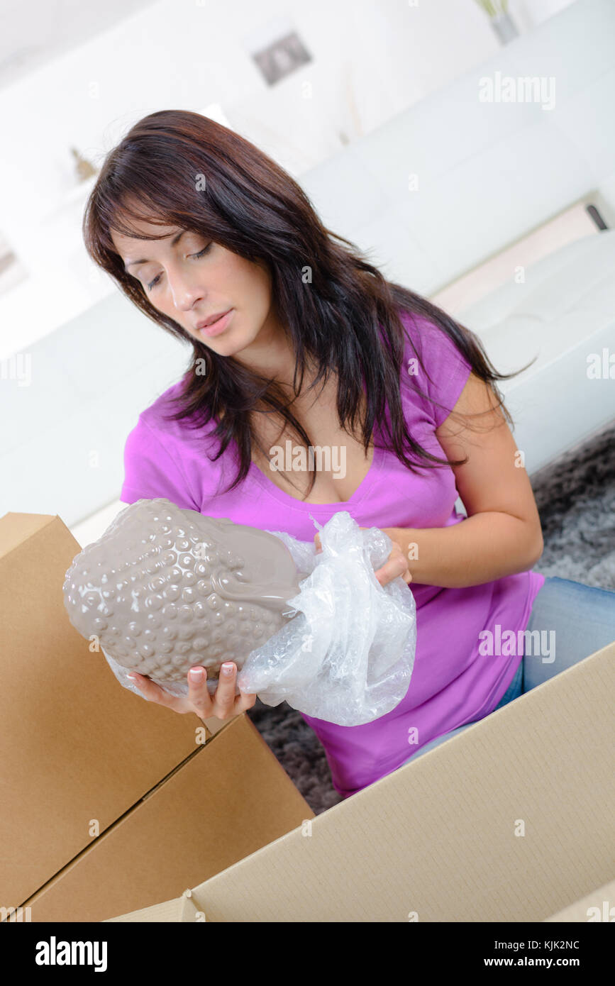 woman unpacking unboxing cardboard carton box Stock Photo - Alamy