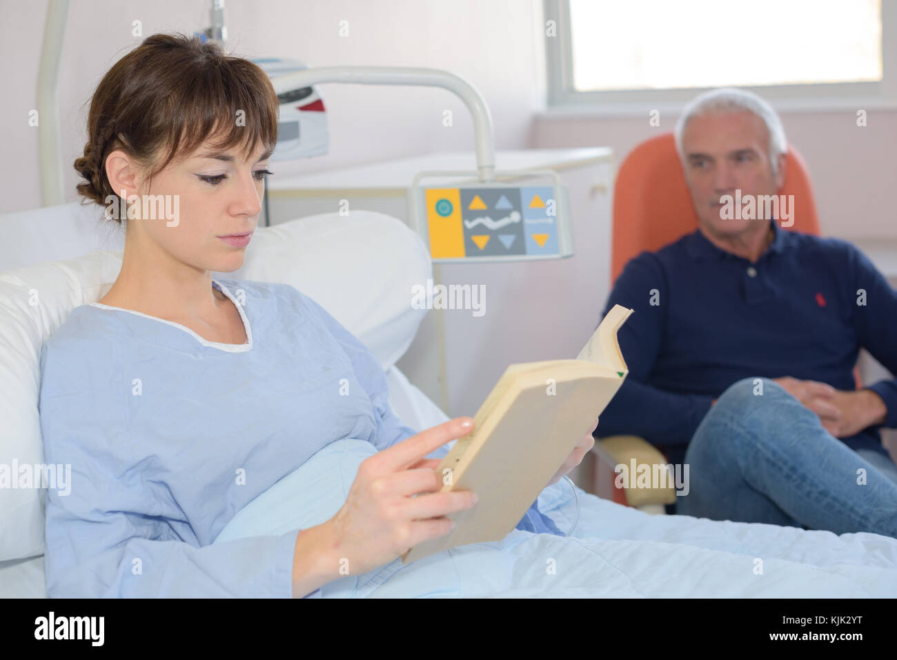 Young woman daughter reading book hi-res stock photography and images ...