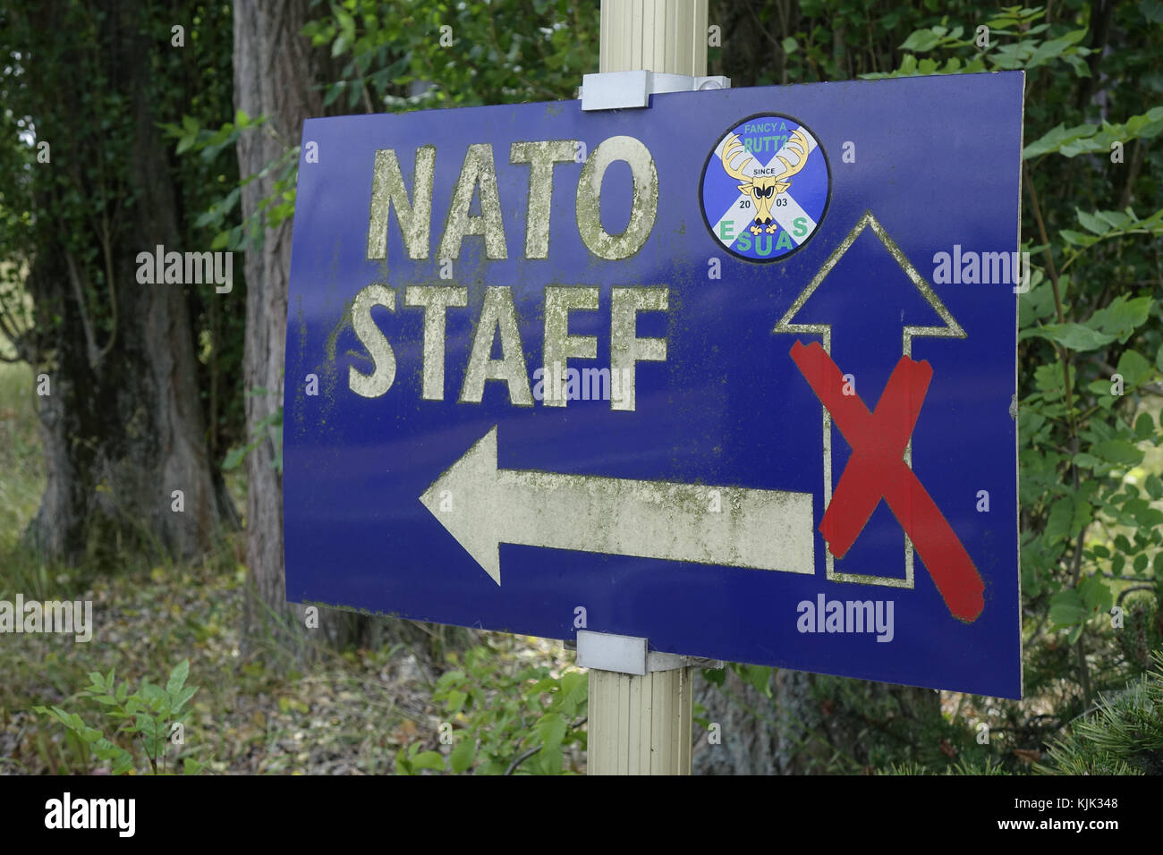 A weathered sign in English pointing to the International Staff (IS ...