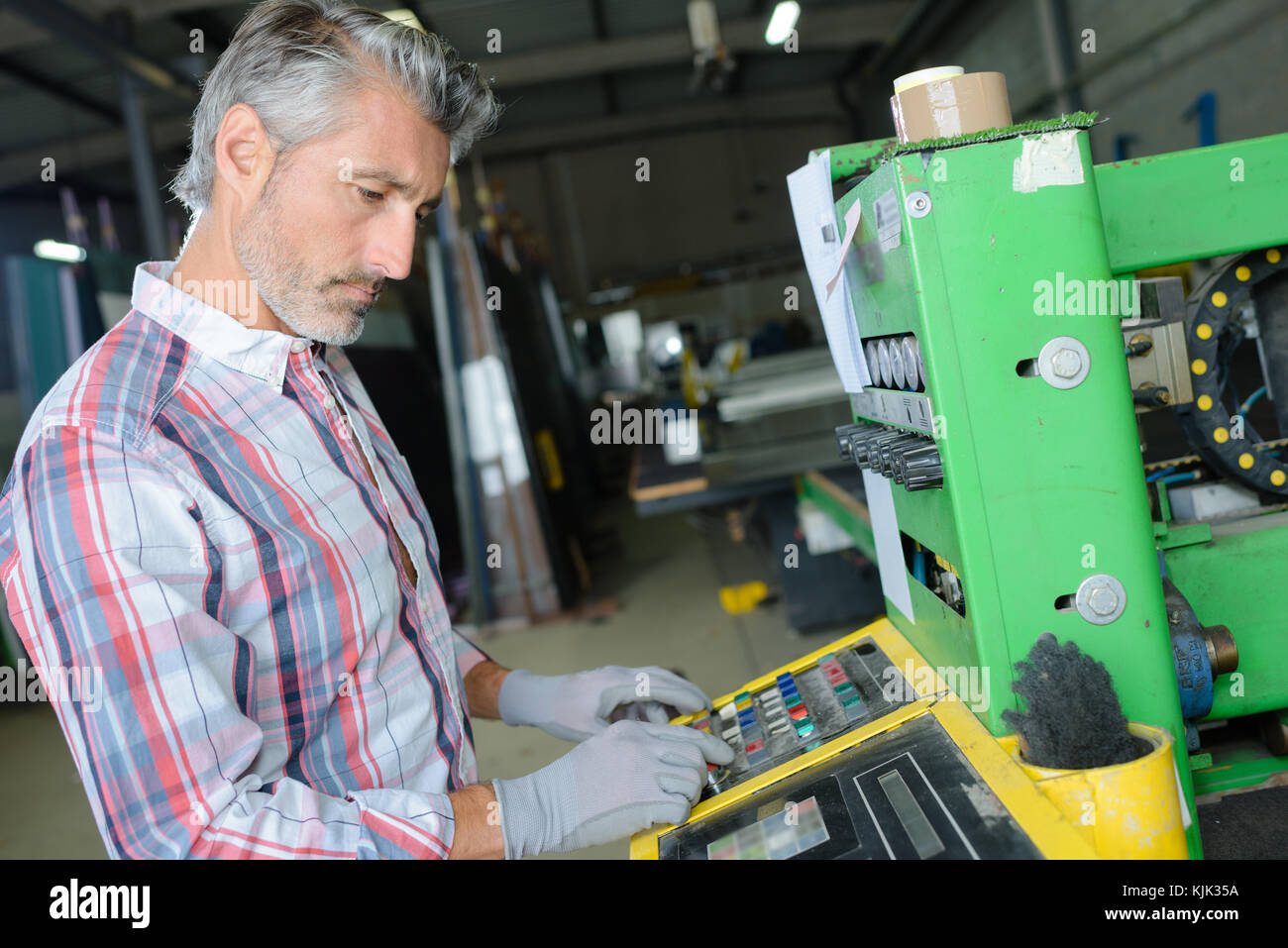 worker operating machine in factory Stock Photo - Alamy
