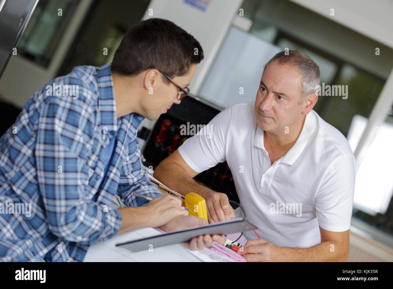electrician apprentice using multimeter teacher monitoring Stock Photo ...