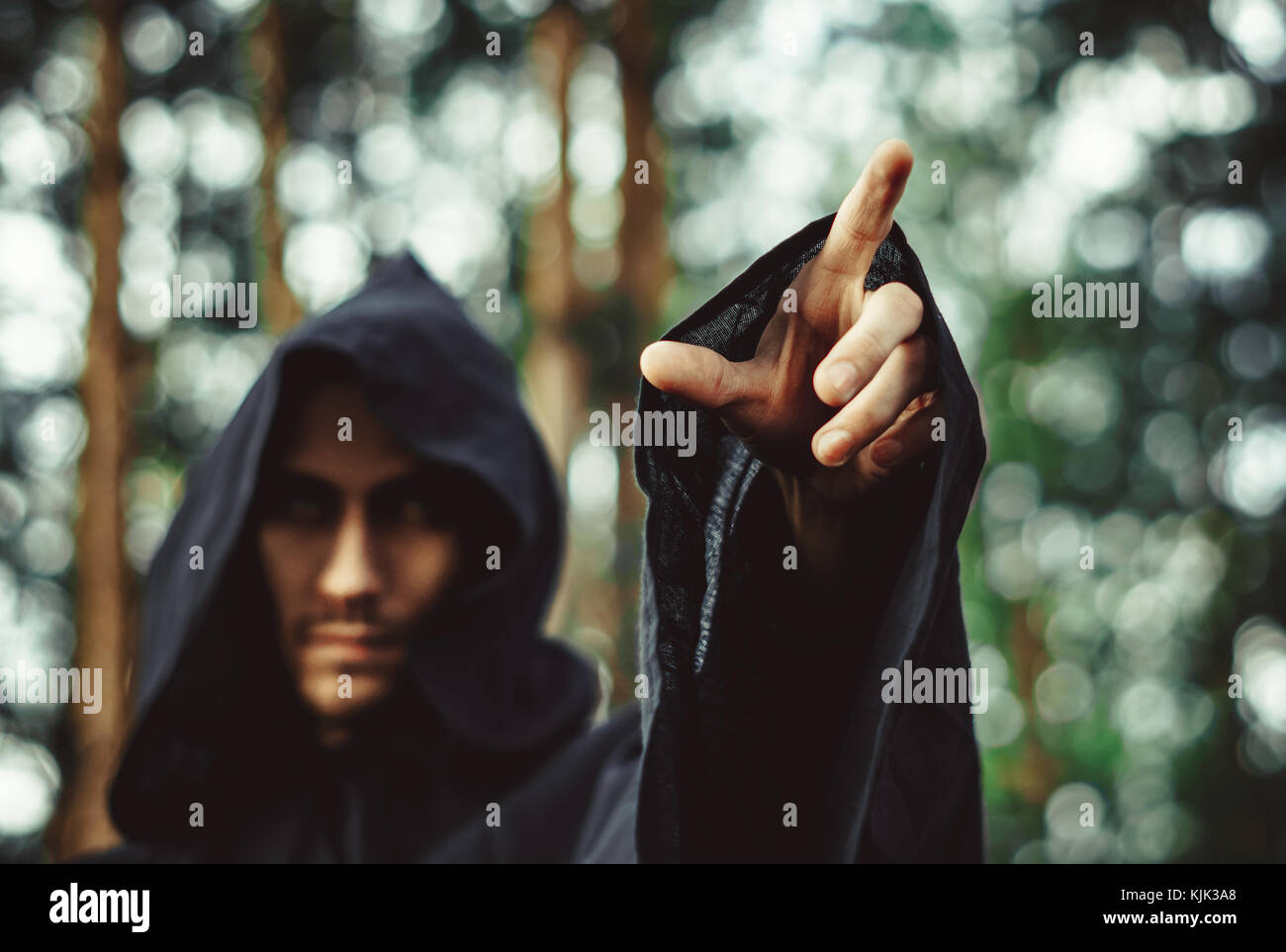 the black monk pointing his finger in the woods Stock Photo - Alamy