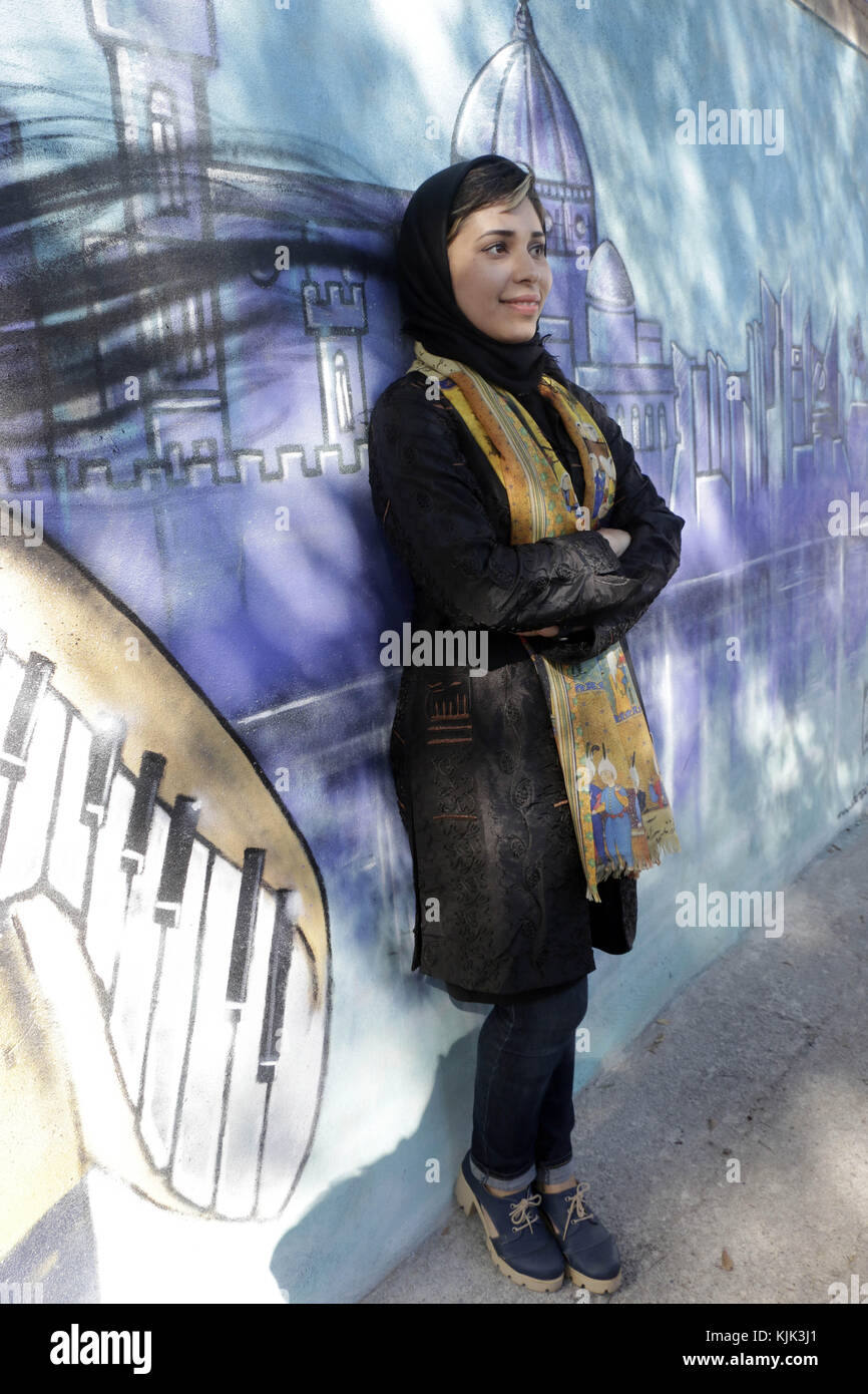 Afghanistan's first female street artist Shamsia Hassani with her mural ...