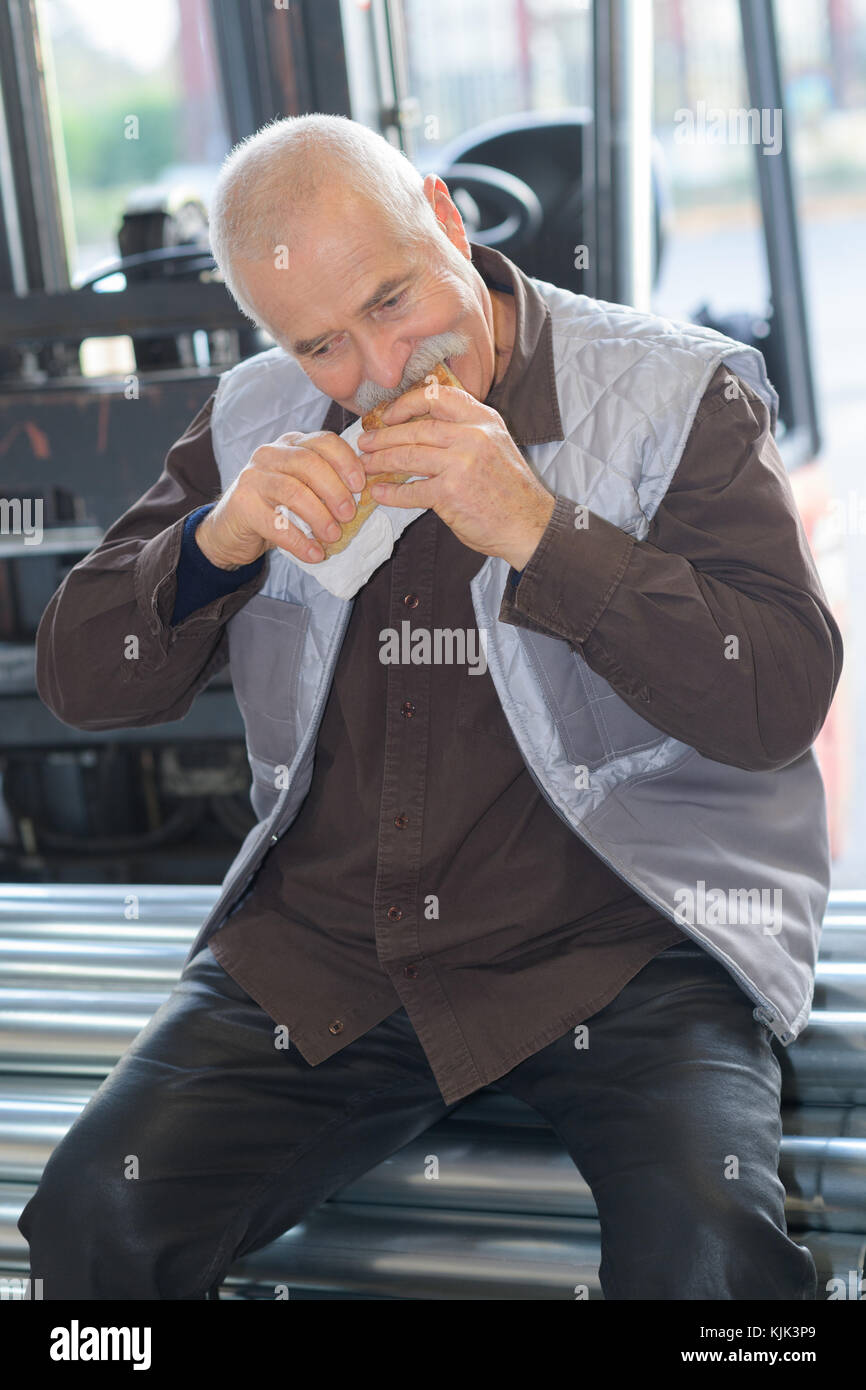 worker eating a bread Stock Photo - Alamy