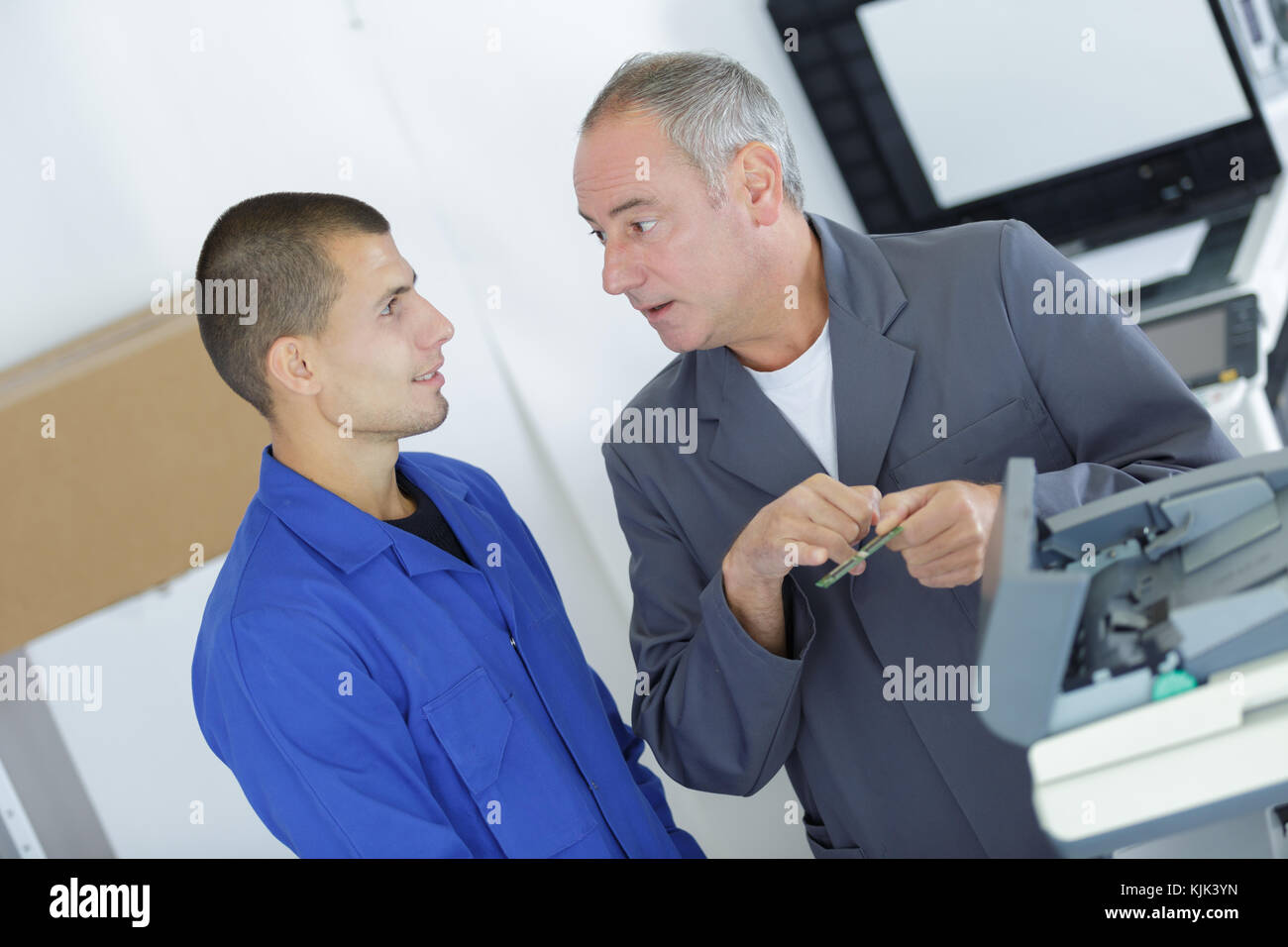 office technicians having a conversation Stock Photo - Alamy