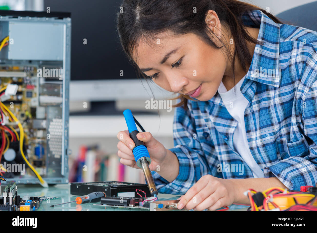young female pc technician welding pc parts Stock Photo - Alamy