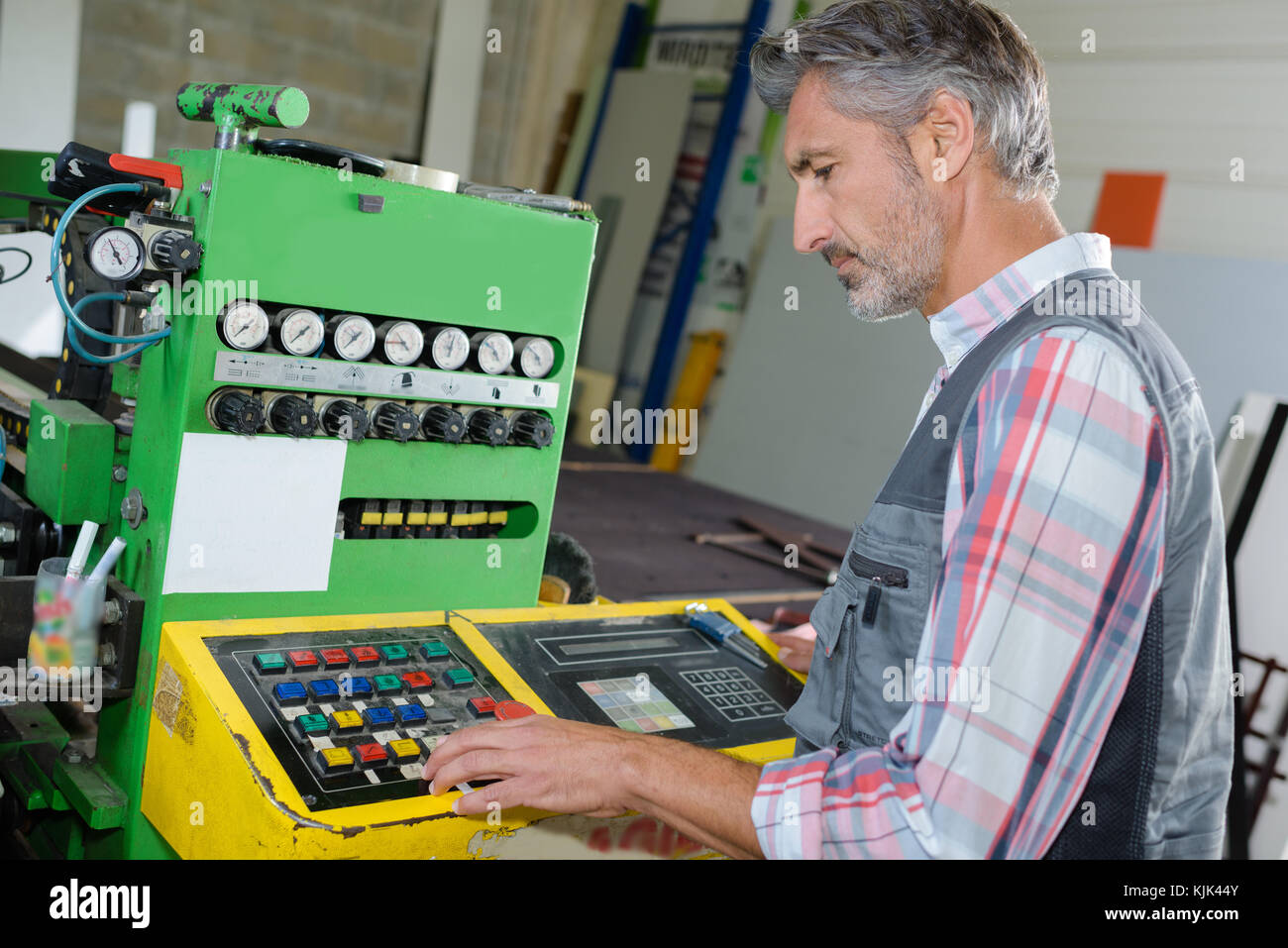 Man pressing buttons on machine hi-res stock photography and images - Alamy