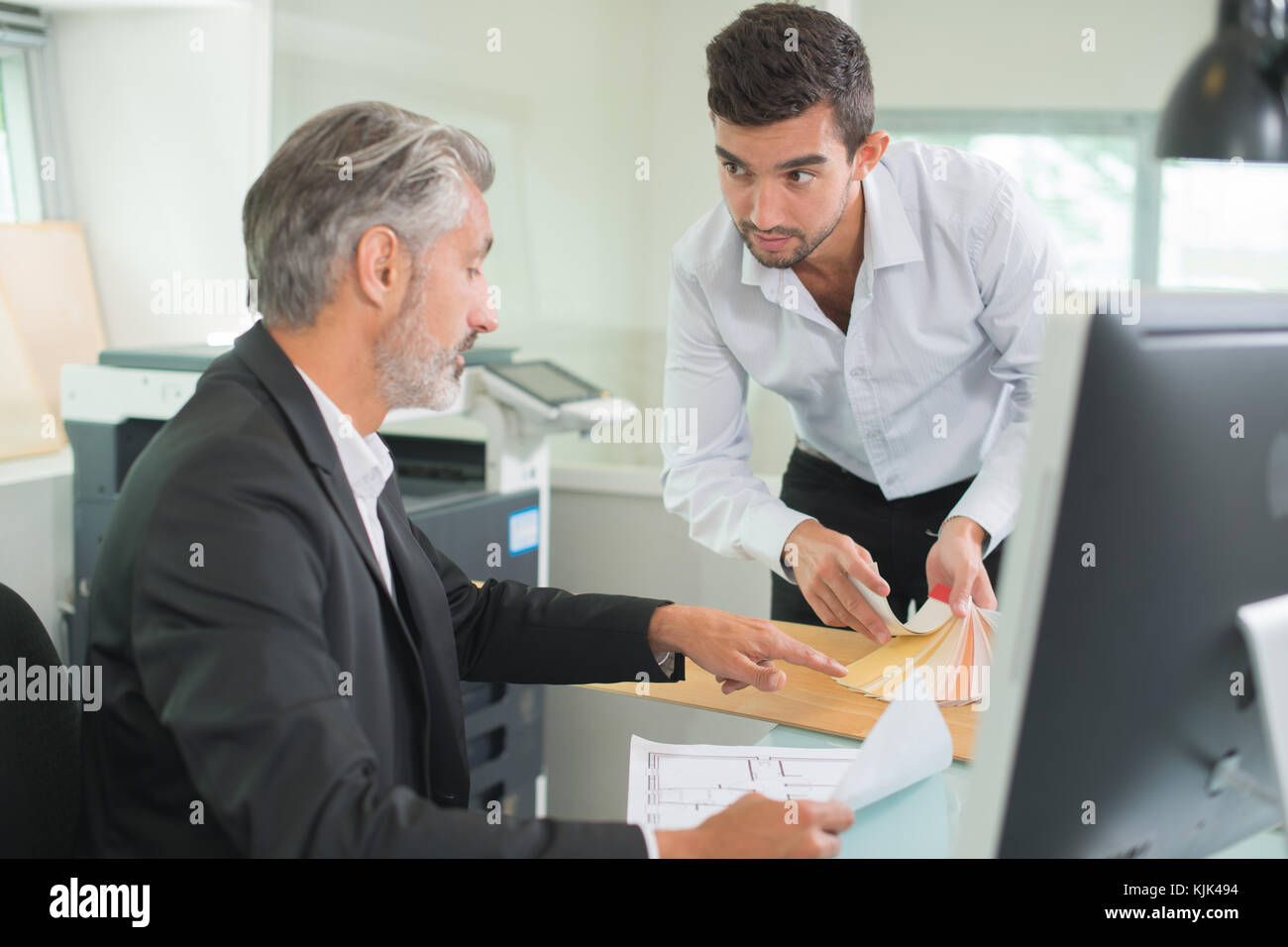 staff showing document to the boss Stock Photo - Alamy
