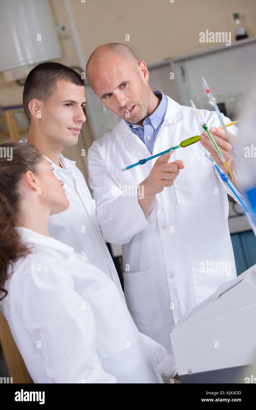 teacher in lab with students Stock Photo - Alamy