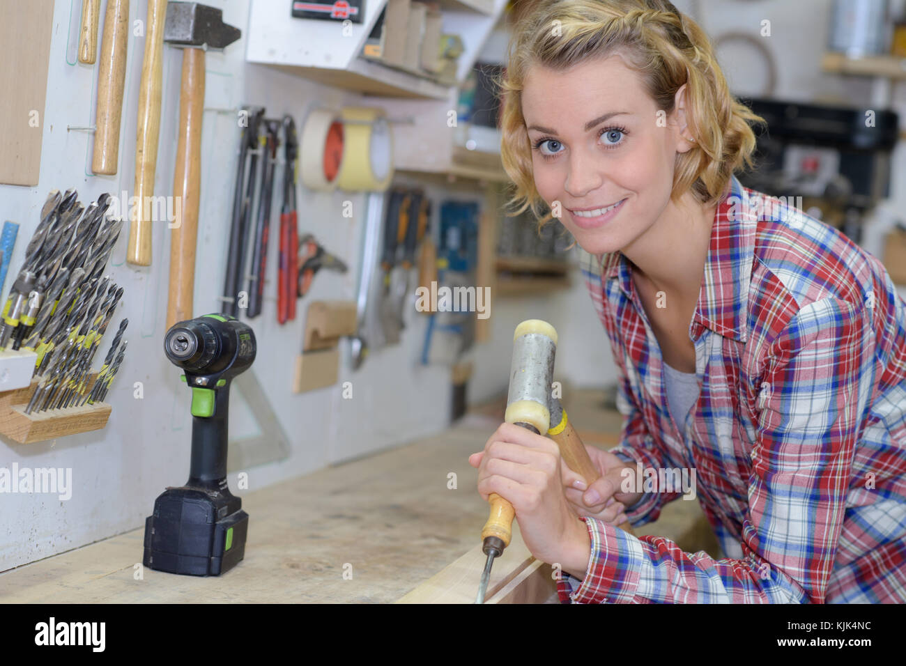 beautiful female carpenter at work using vertical drilling machine Stock Photo - Alamy