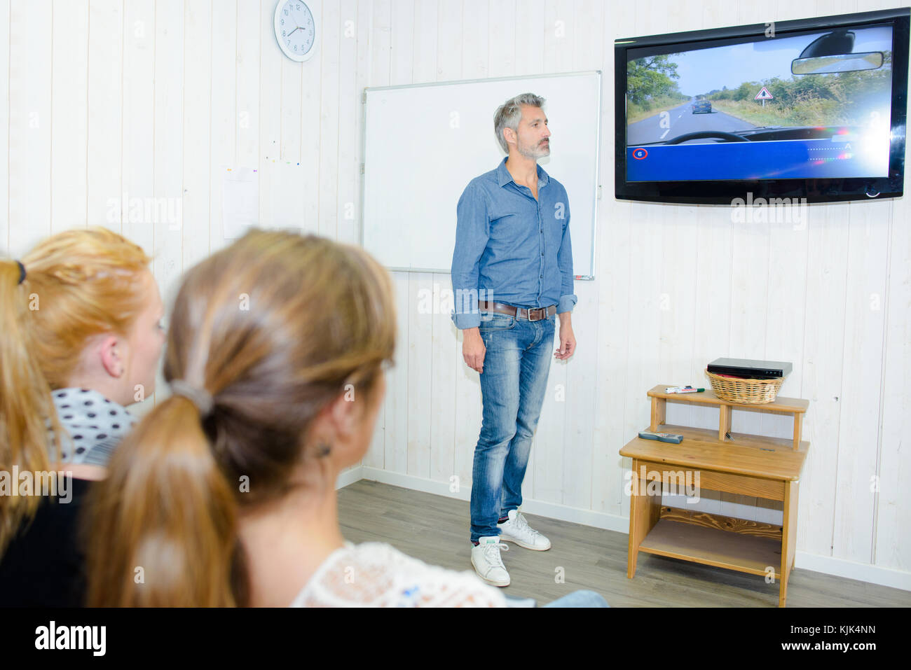 driving instructor standing in front of a screen Stock Photo - Alamy