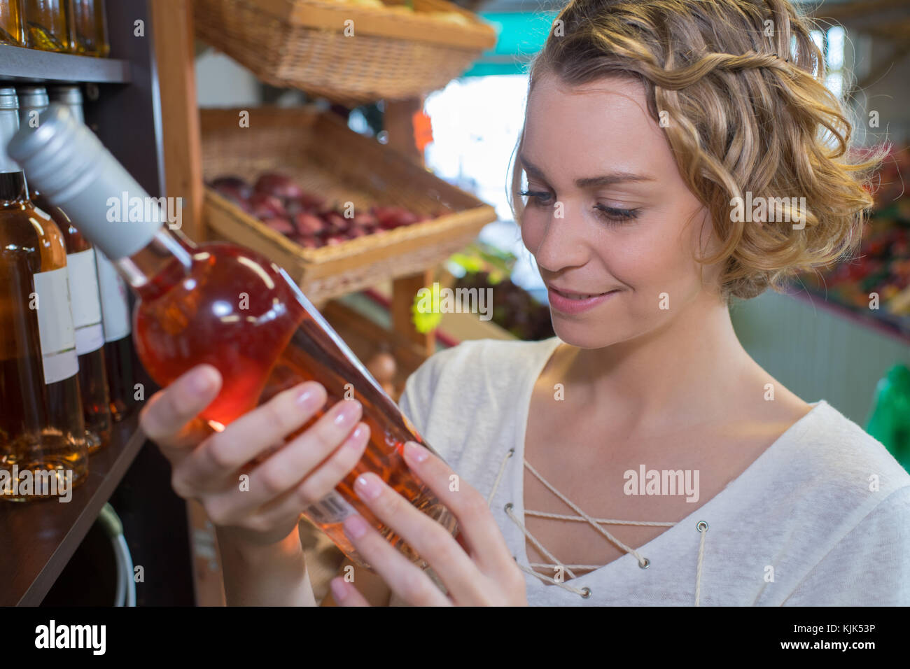 woman choosing wine bottles Stock Photo - Alamy
