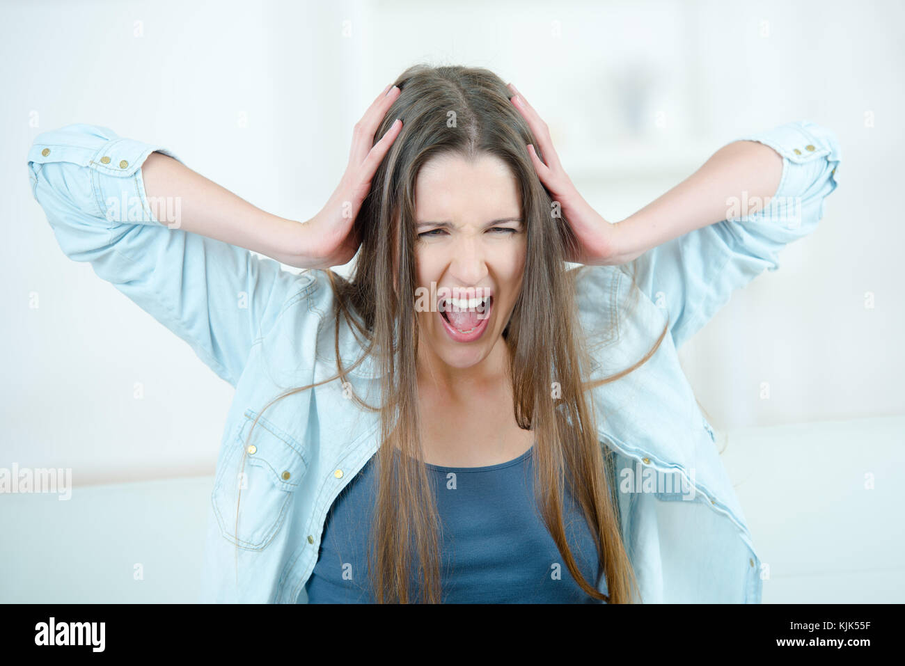 Woman yelling hands on head hi-res stock photography and images - Alamy